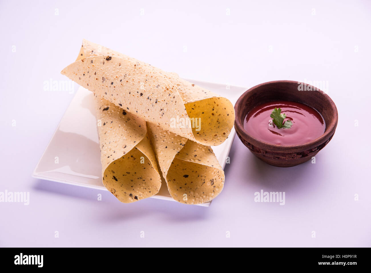 masala papad or roll papad indian vegetarian crispy food or starter ...