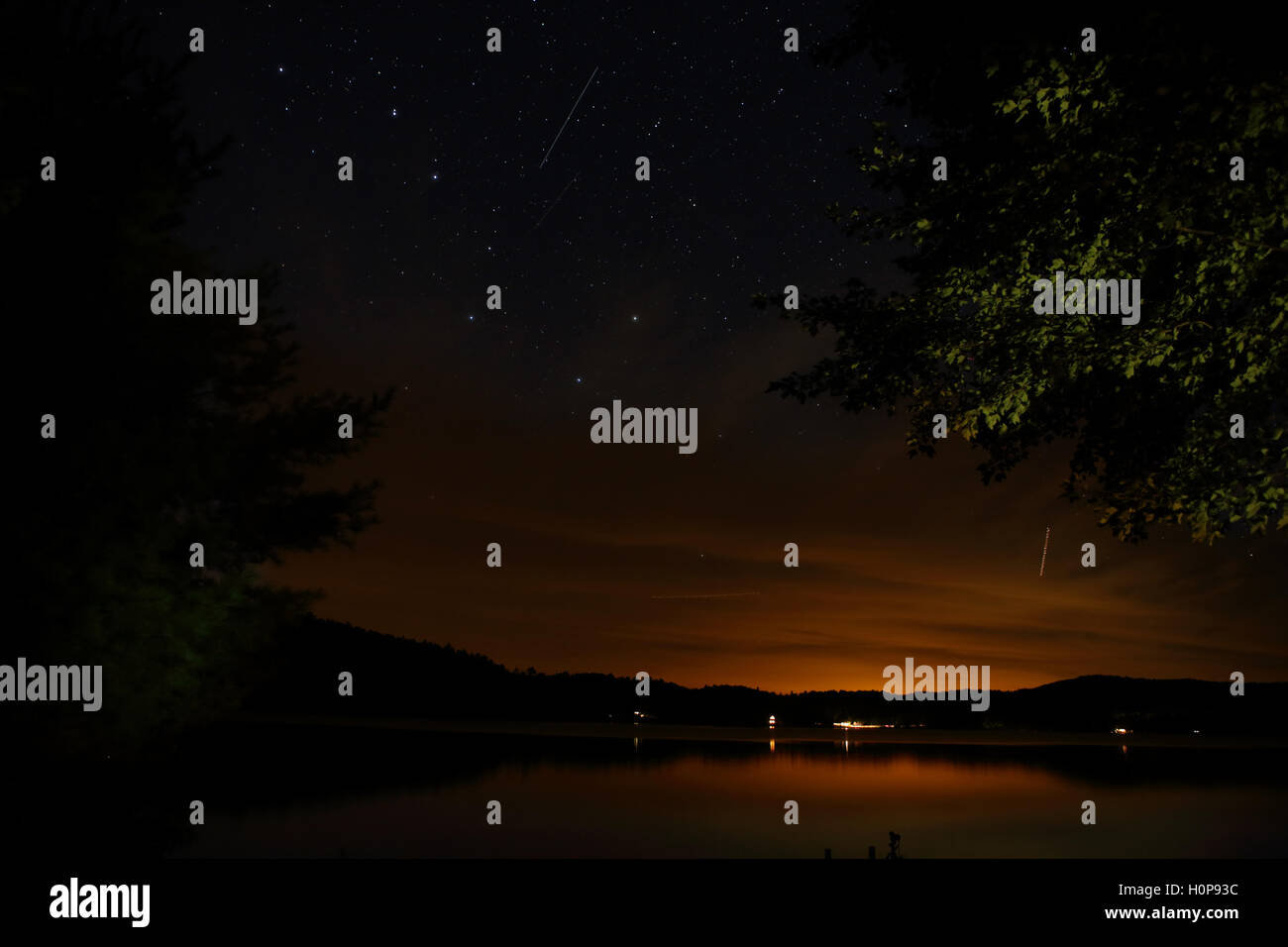 August night sky with stars and a meteor trail through the Big Dipper ...