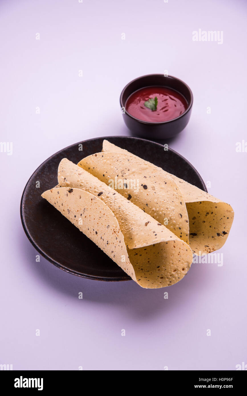 masala papad or roll papad indian vegetarian crispy food or starter ...