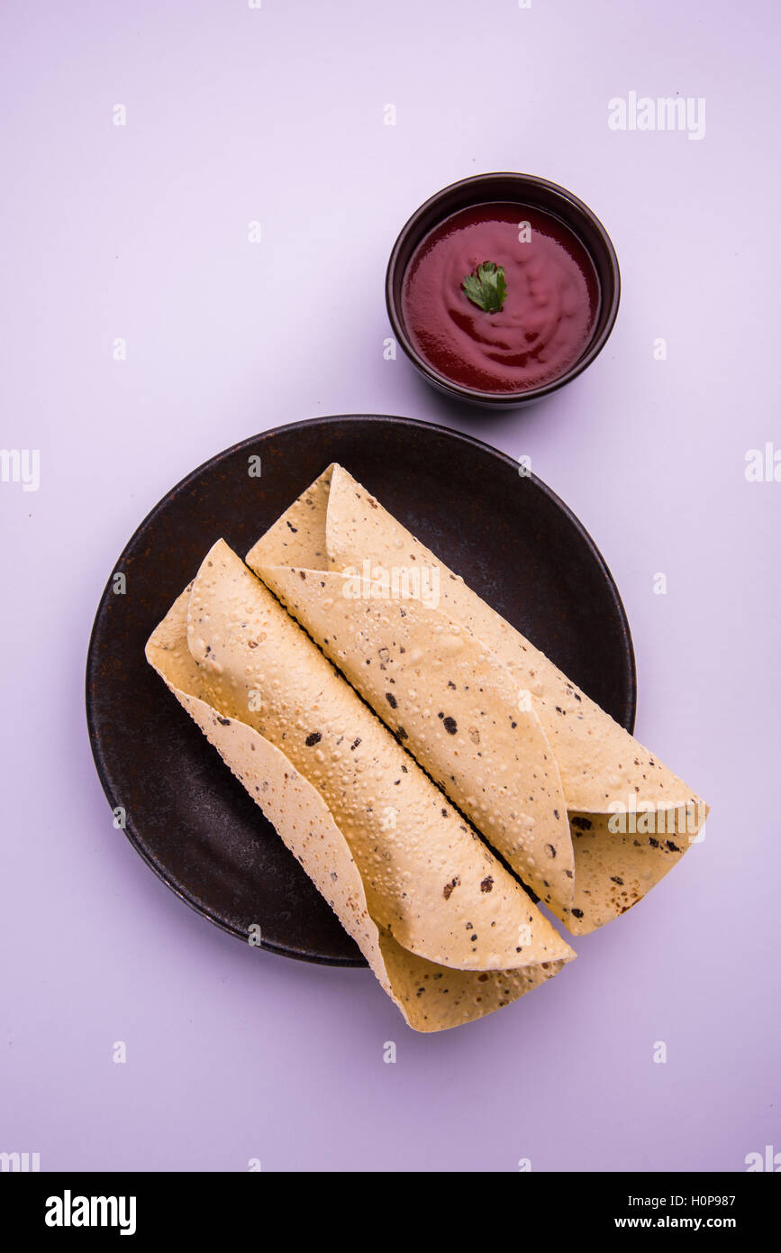 masala papad or roll papad indian vegetarian crispy food or starter ...