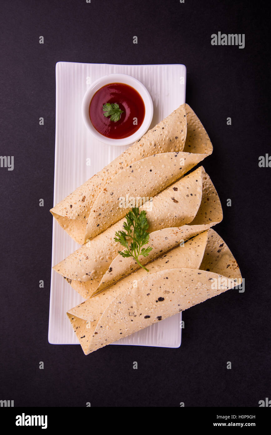 masala papad or roll papad indian vegetarian crispy food or starter ...