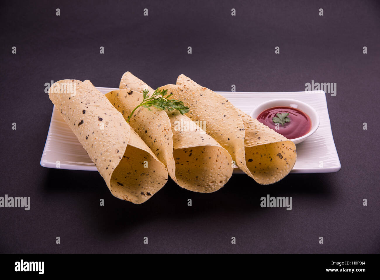 masala papad or roll papad indian vegetarian crispy food or starter ...