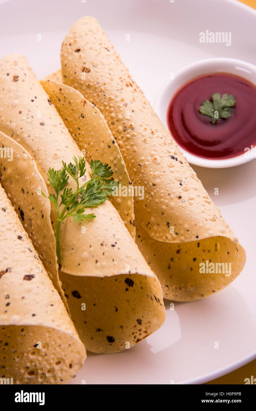 masala papad or roll papad indian vegetarian crispy food or starter ...