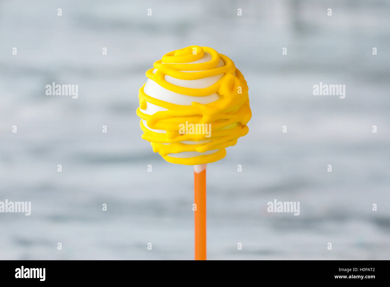 Cake with icing on stick Stock Photo - Alamy