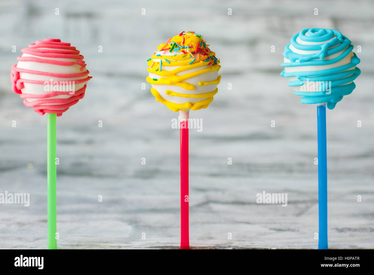 Three cake lollipops Stock Photo - Alamy