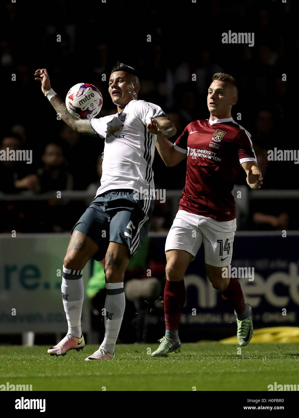 Northampton Town's Sam Hoskins (right) and Manchester United's Marcos ...