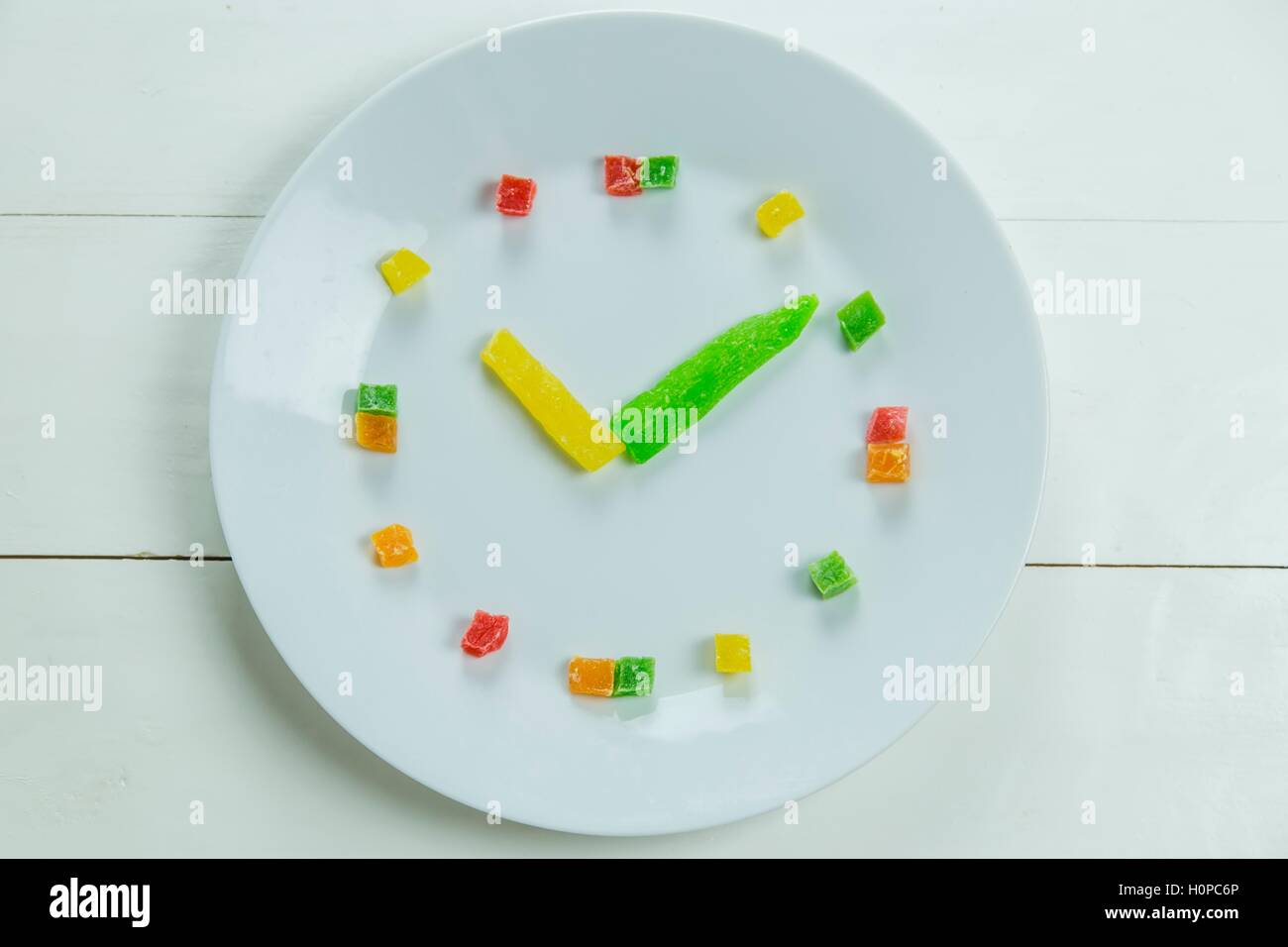 Fruit clock with candied fruits Stock Photo - Alamy