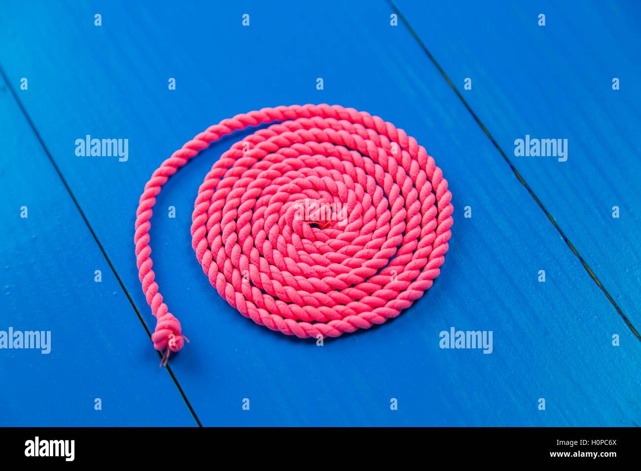 Pink rope circle on blue background Stock Photo - Alamy