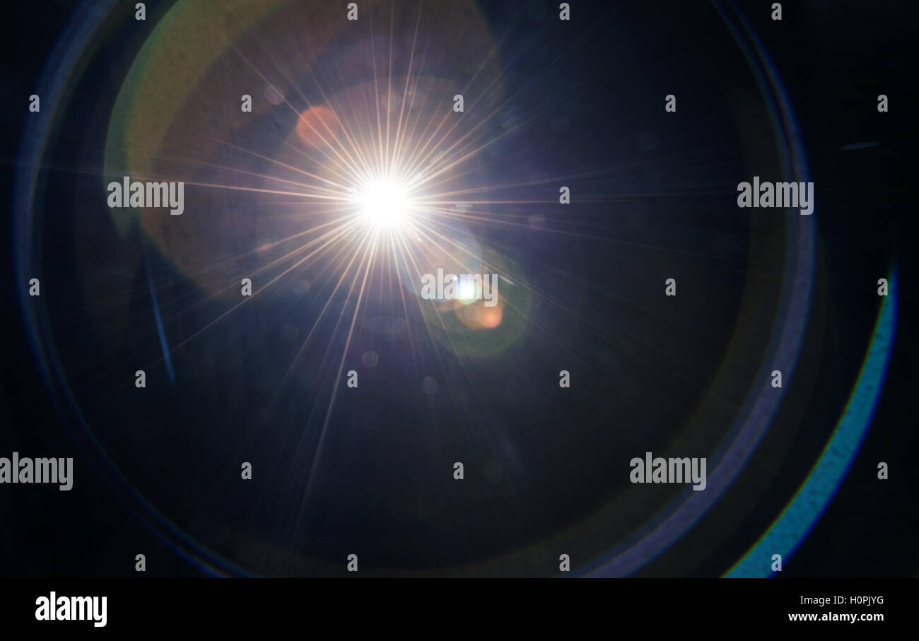 Natural lens flare on a dark background Stock Photo - Alamy
