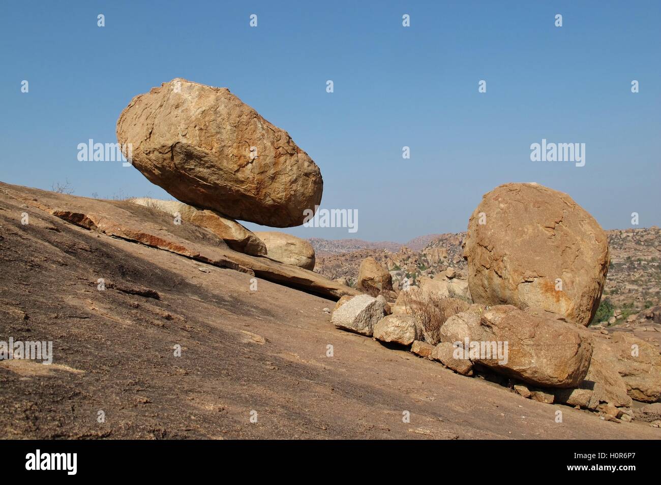 Stunning scene in Hampi, India. Big granite boulder balancing on a ...