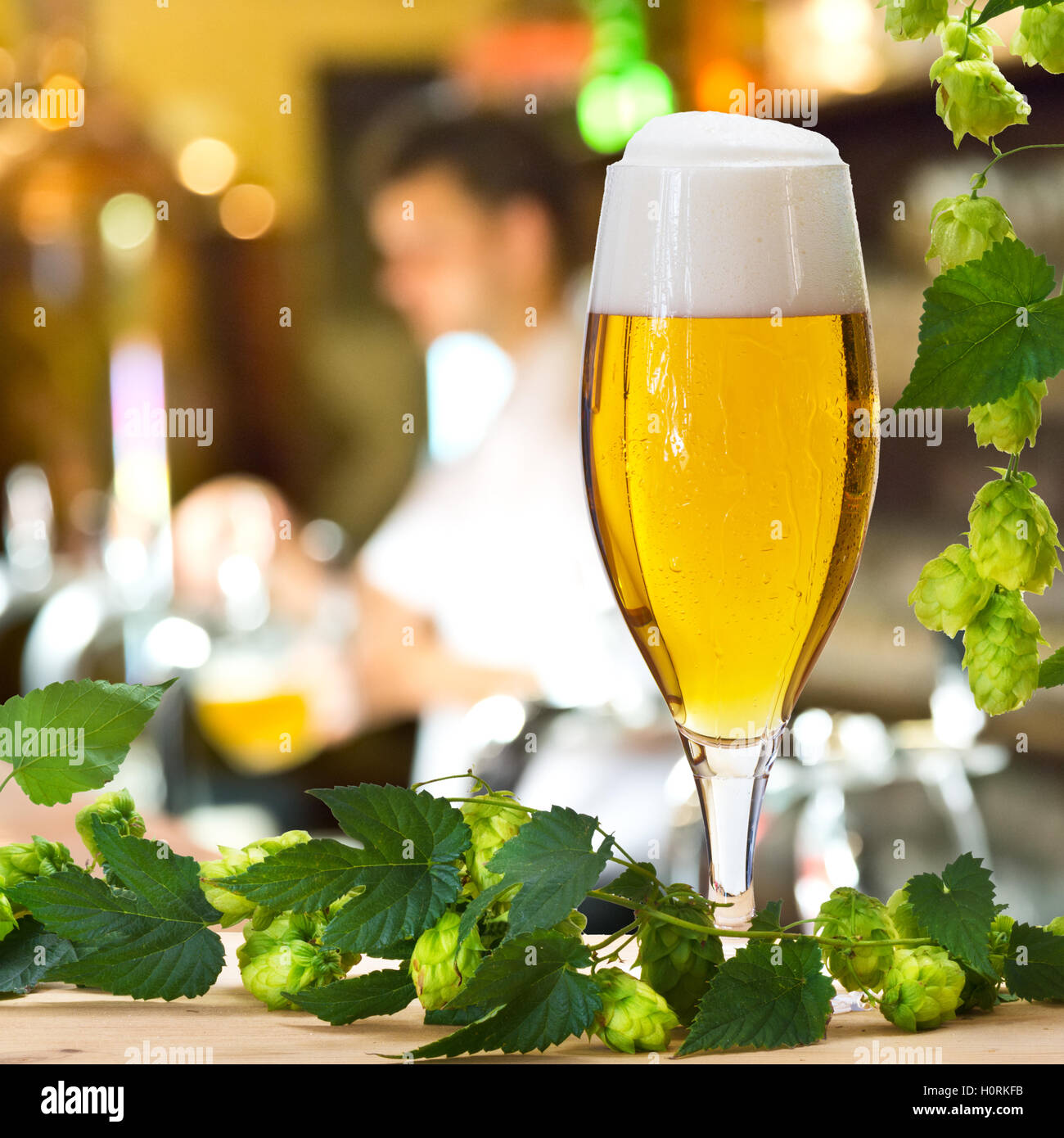 Beer glass and hops in the pub Stock Photo - Alamy