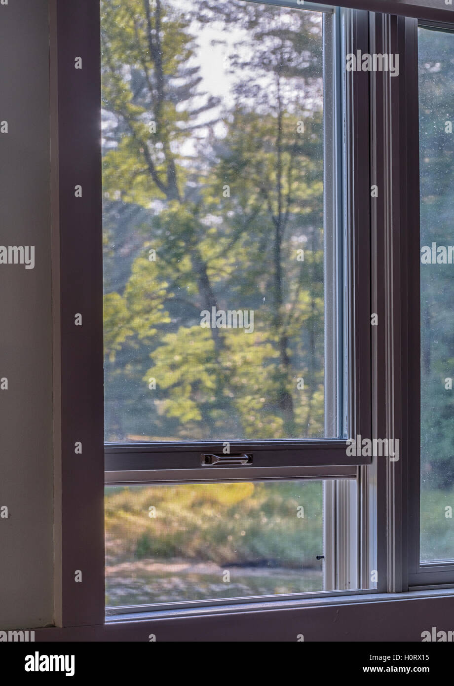 Looking out through window onto lake in early morning Stock Photo - Alamy