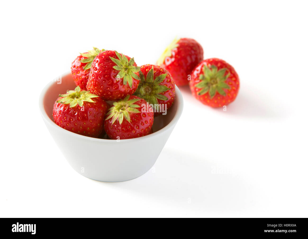 Strawberry in bowl isolated Stock Photo - Alamy