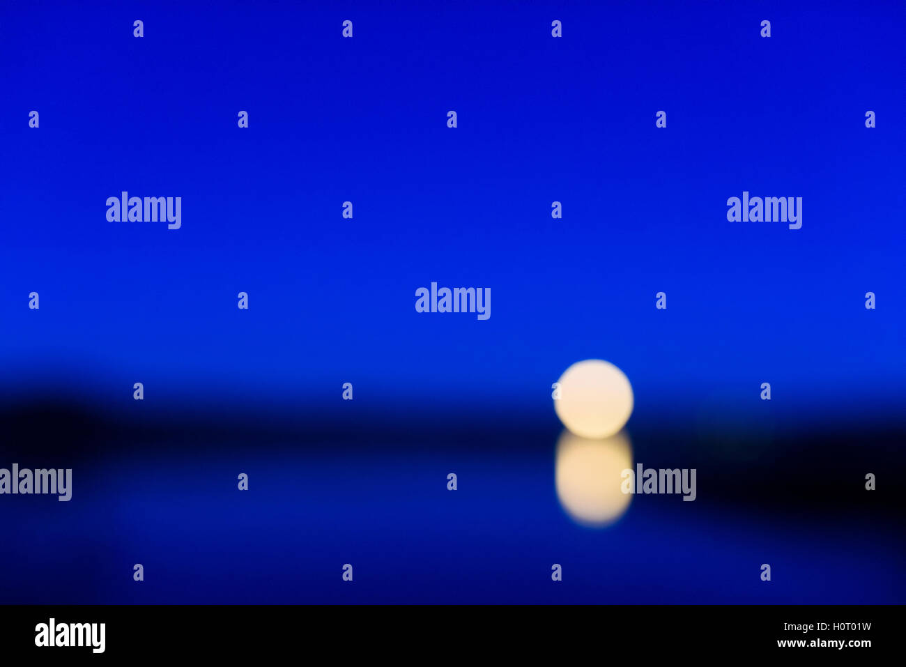 Moonrise over lake Stock Photo - Alamy