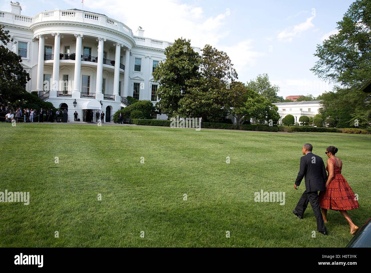 U.S. President Barack Obama and First Lady Michelle Obama walk across ...