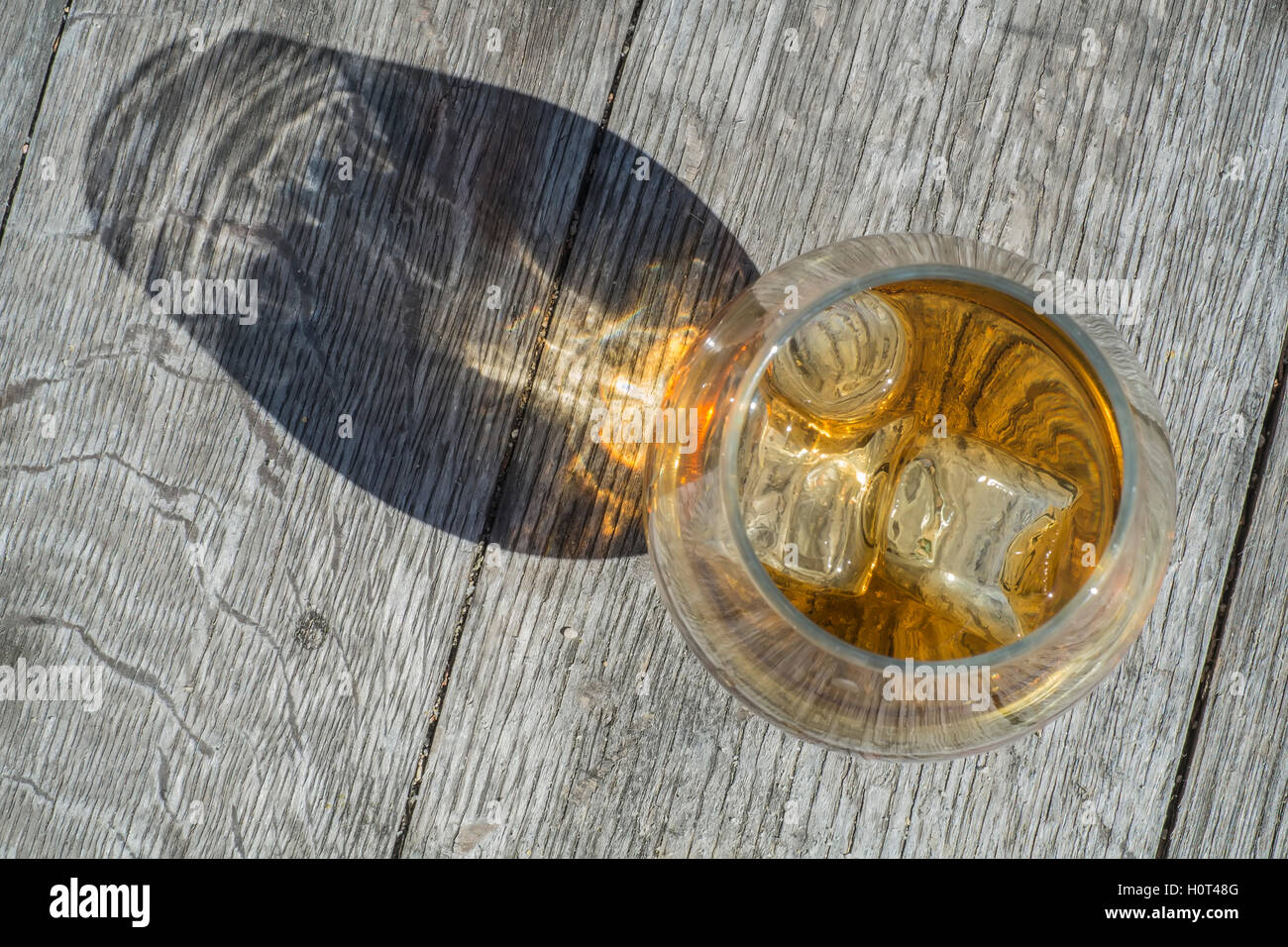Brandy on the rocks on a wooden table Stock Photo - Alamy