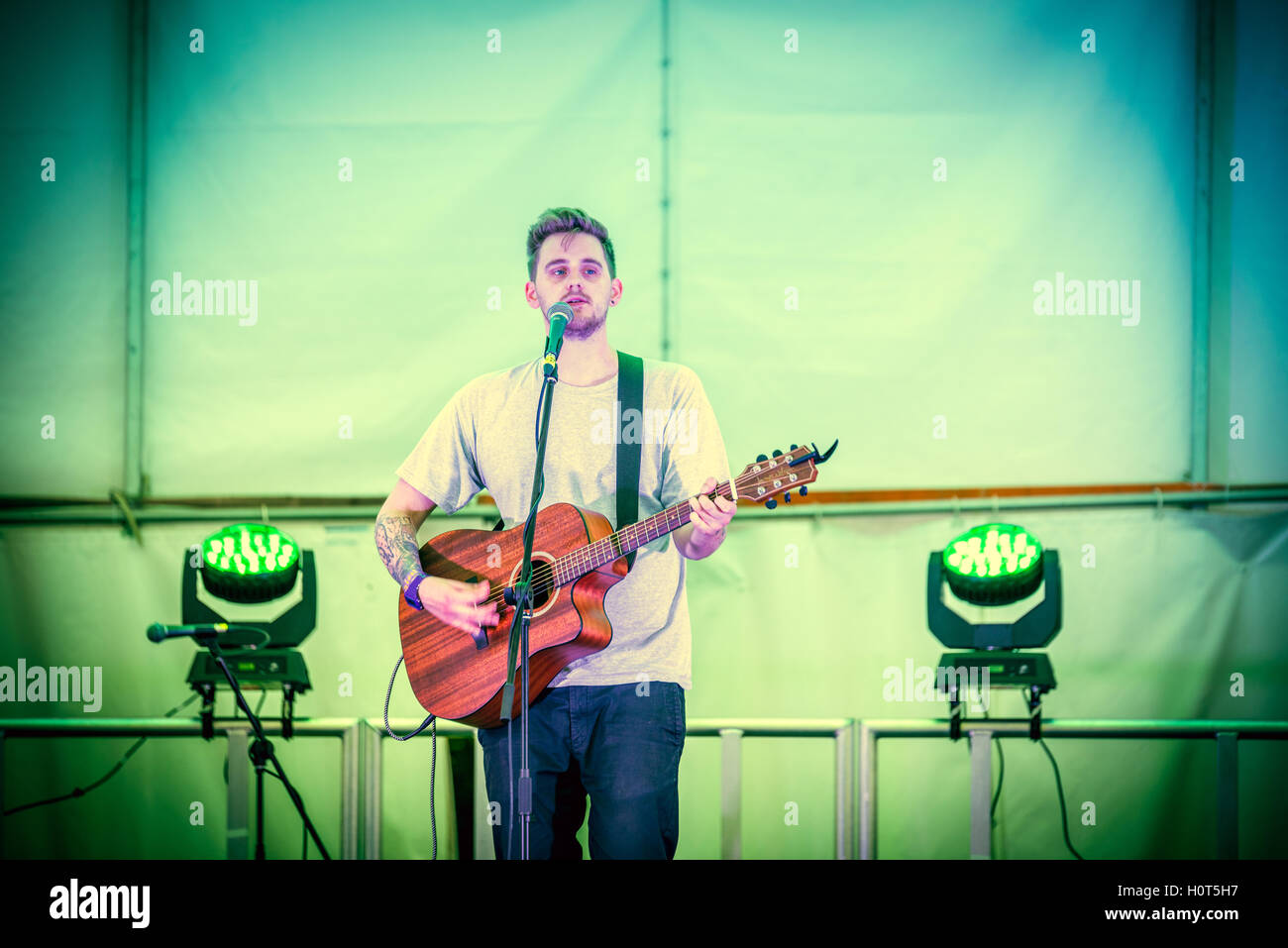 A Man Singing And Playing Guitar On Stage Stock Photo Alamy a-man-singing-and-playing-guitar-on-stage-stock-photo-alamy