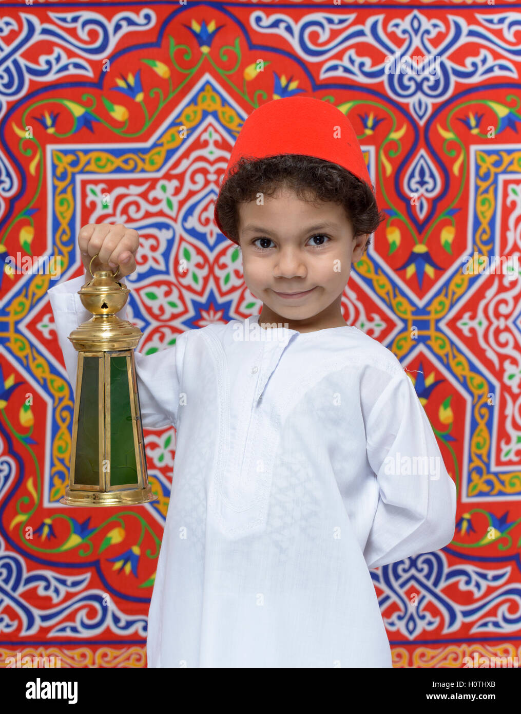 Happy Arabian Boy with Fez and Lantern Celebrating Ramadan Stock Photo ...