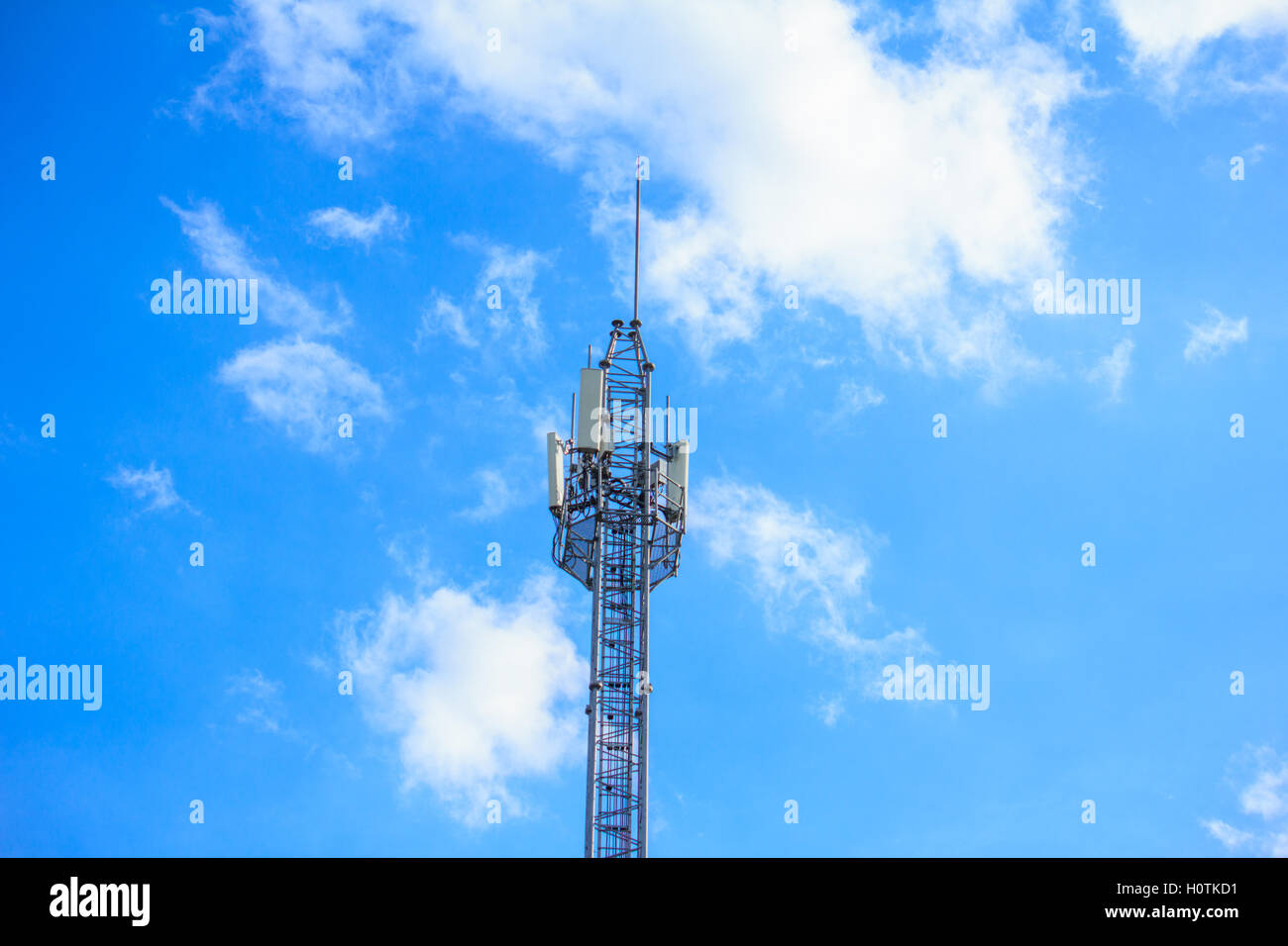 White Cellular Tower with blue sky and clouds Stock Photo - Alamy