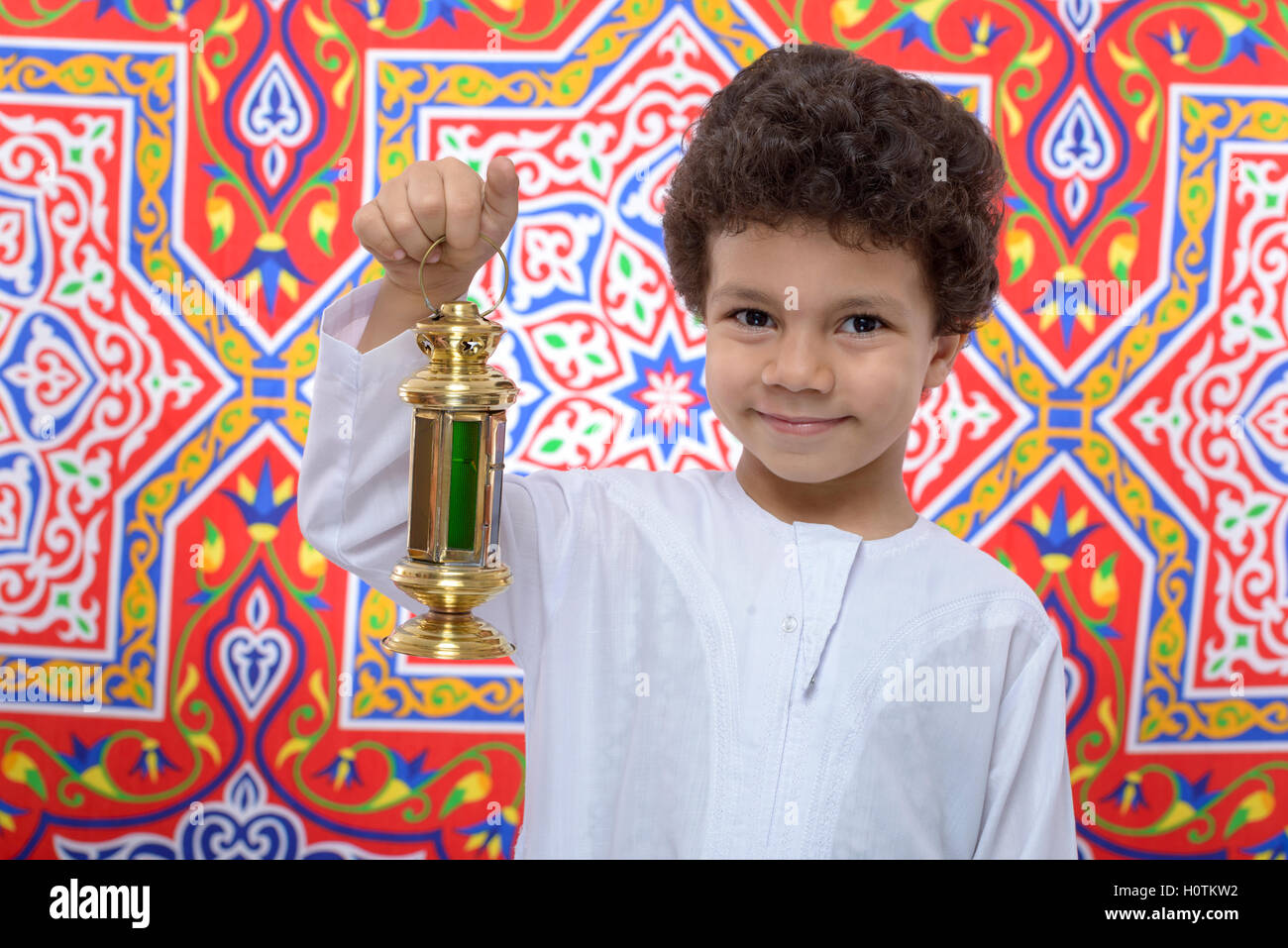 Happy Boy with Golden Lantern Celebrating Ramadan over Ramadan Fabric ...