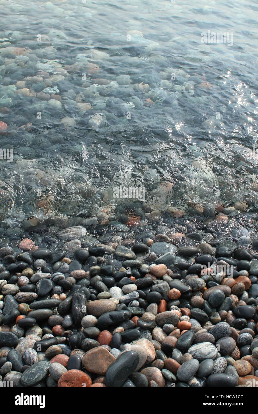 Pebble Beach with clear water Stock Photo - Alamy