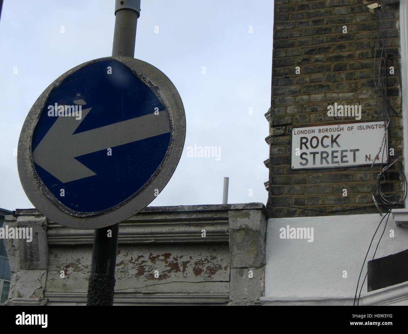 Black and white arrow sign and Rock Street street sign, London image ...