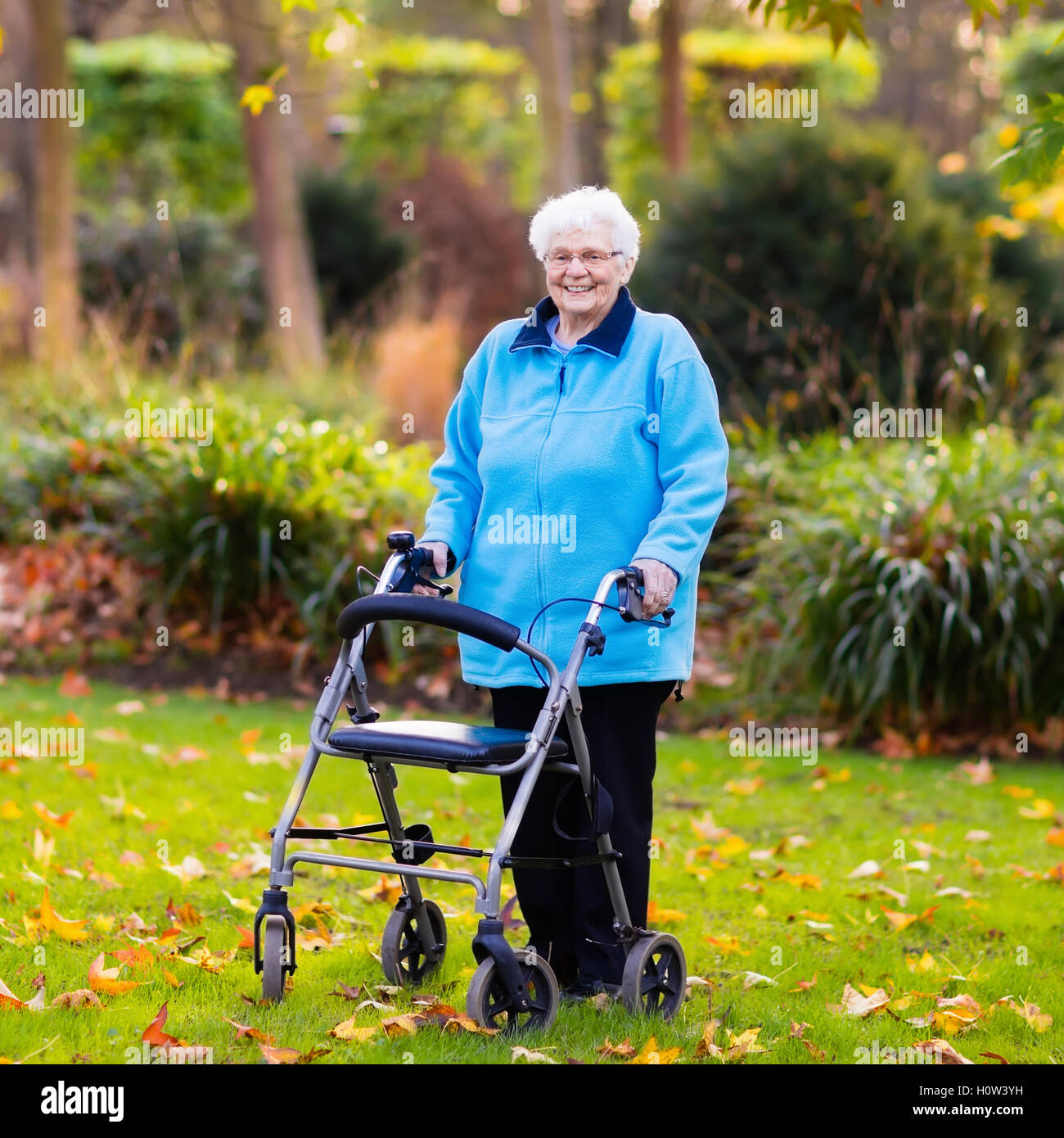 Happy senior handicapped lady with a walking disability enjoying a walk ...