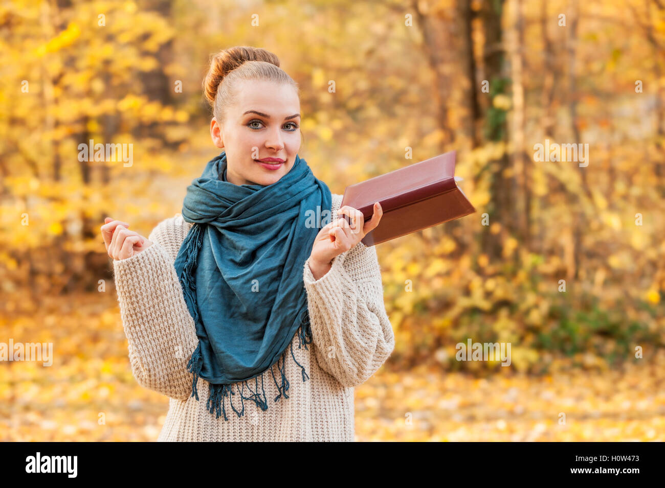 Happy cheerful female just finished reading a book outside in the ...