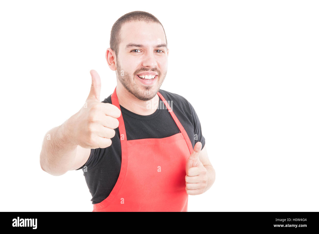 Cheerful supermarket employee showing double like sign on white studio ...