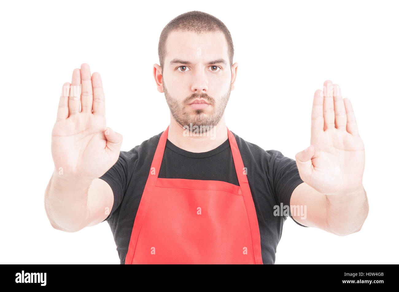 Portrait of serious employee doing stop sign with both hands isolated ...