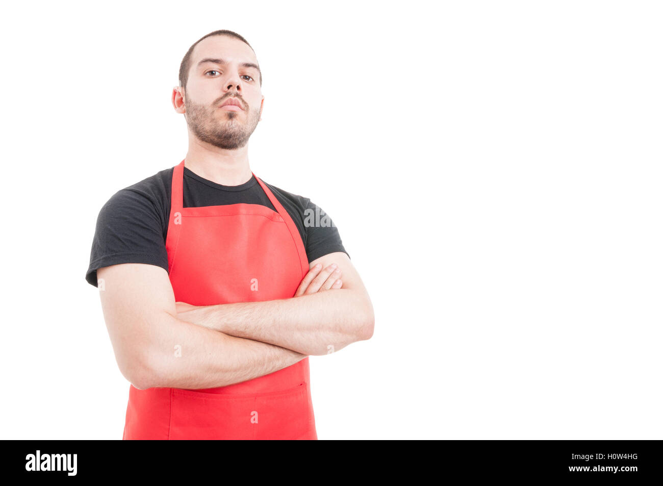 Confident butcher posing with folded arms on white background with copy ...