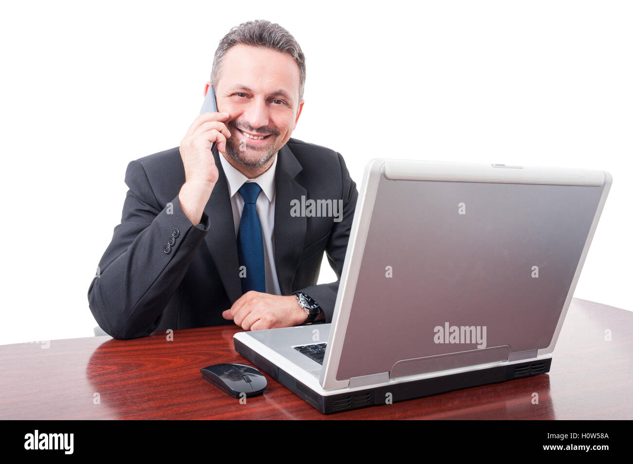 Friendly manager talking on cellphone in his office isolated on white ...
