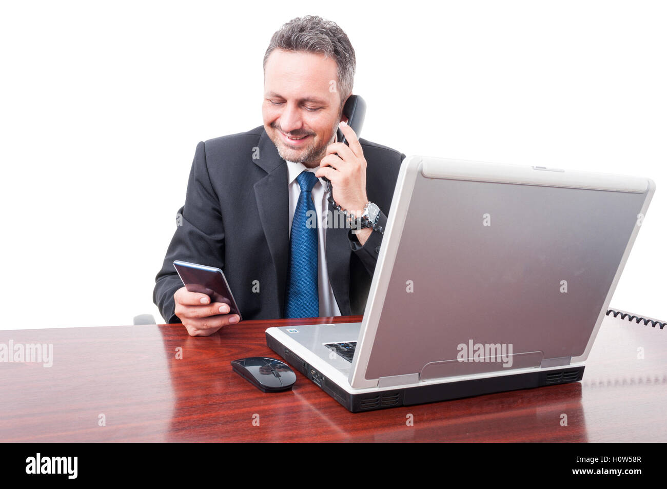 Confident lawyer talking on desk telephone and typing message on ...