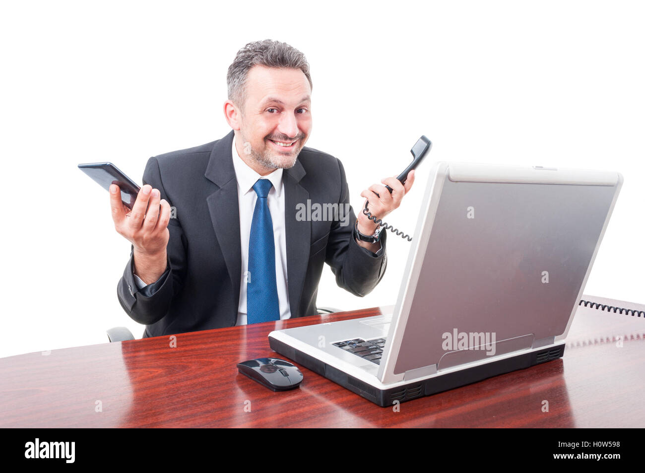 Smiling manager holding smartphone and receiver as busy work concept ...