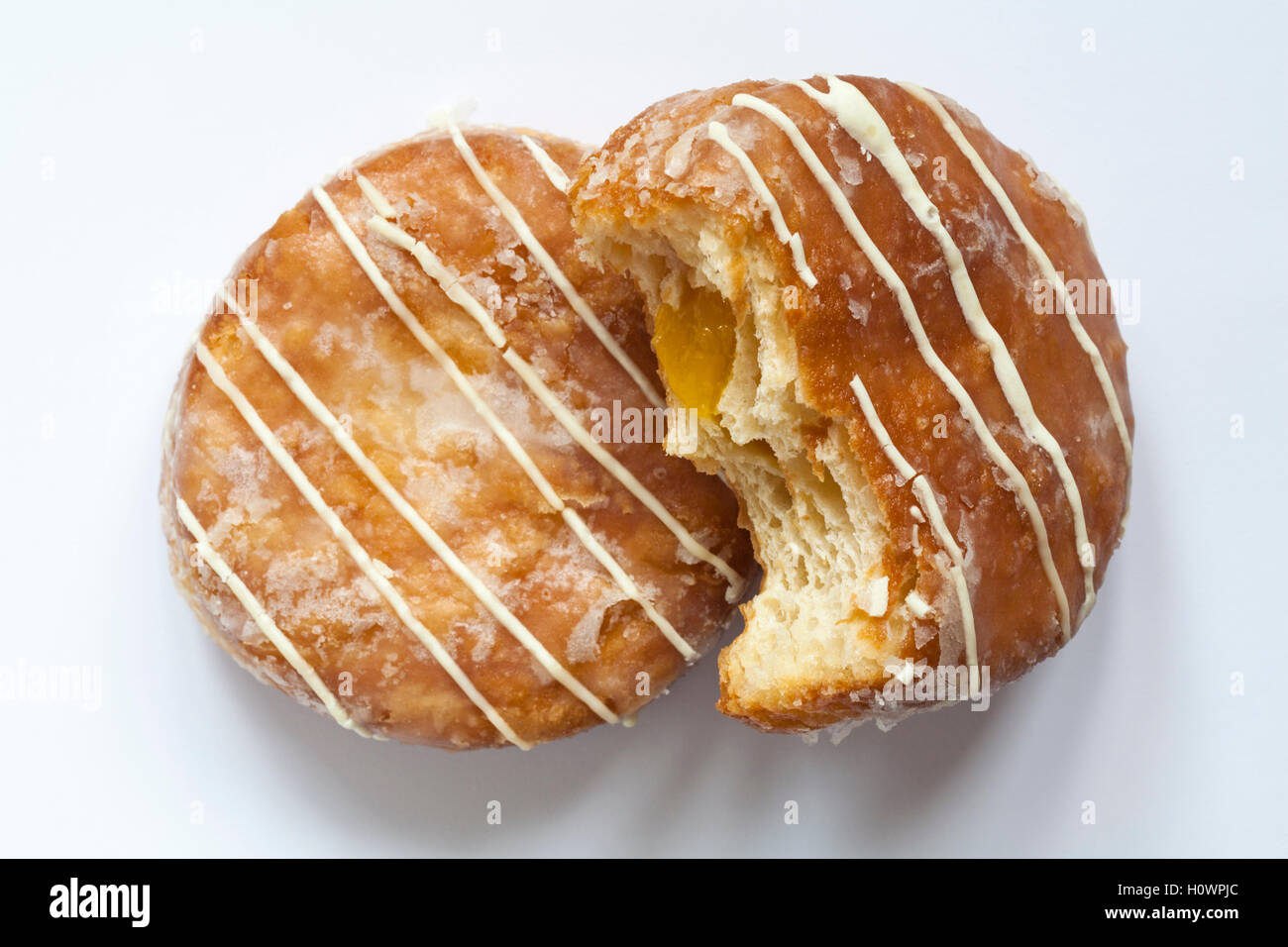 M&S Passion Fruit Yum Yums iced doughnuts one bitten into isolated on ...