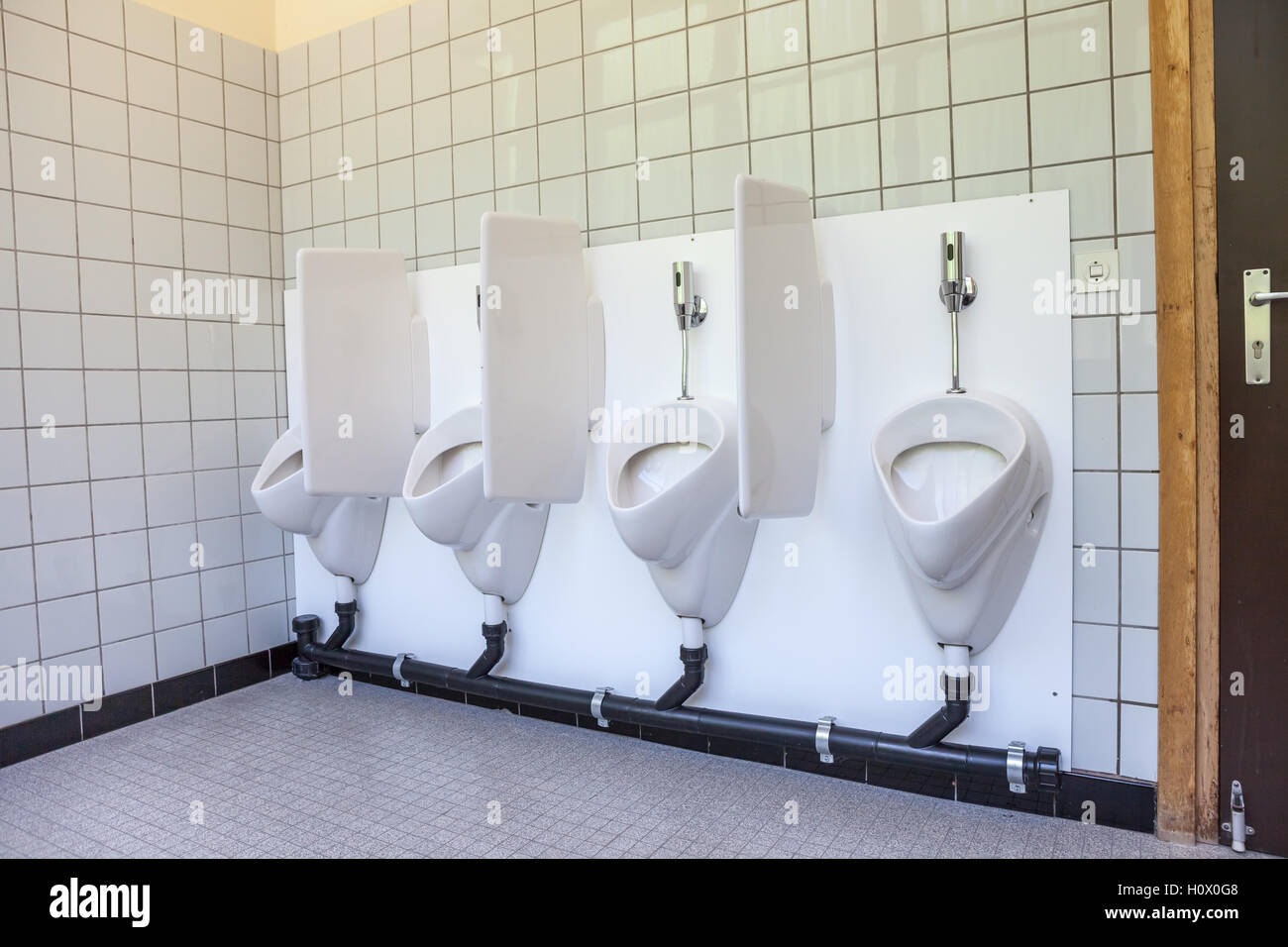 urinals in an old building for men only Stock Photo - Alamy