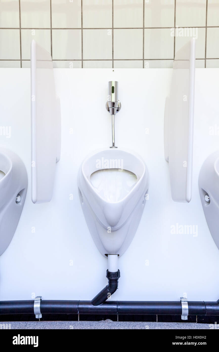 urinals in an old building for men only Stock Photo - Alamy