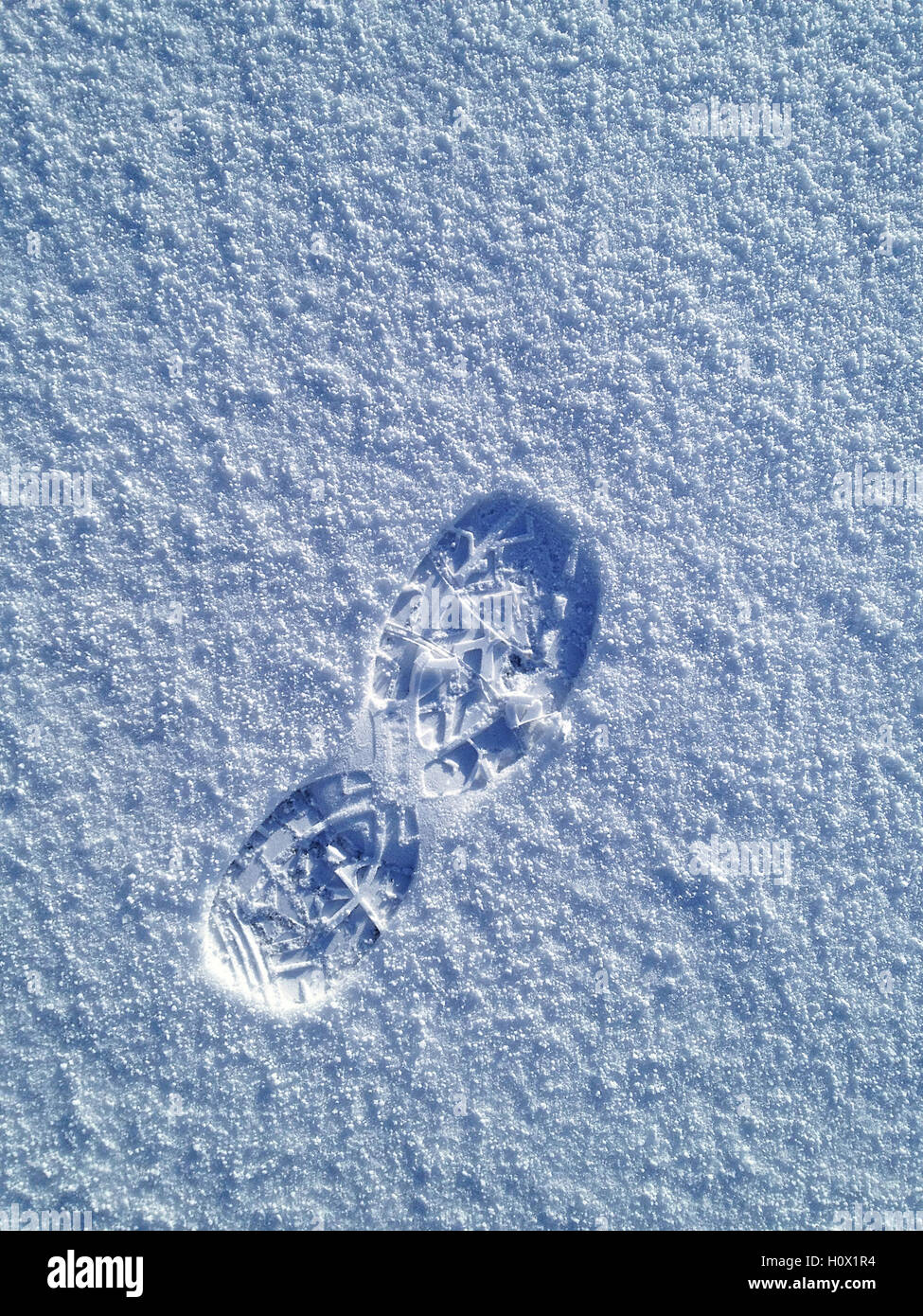 Footprint on snow Stock Photo - Alamy