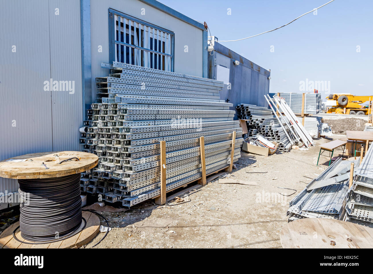 Cable trays and cord spools are stacked among container office is ...