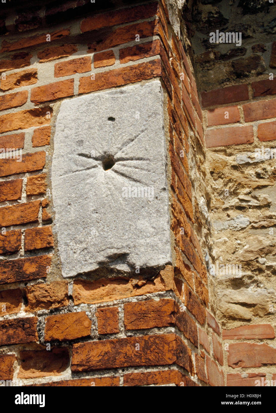 Medieval stone sundial or Mass dial set into a buttress beside the ...