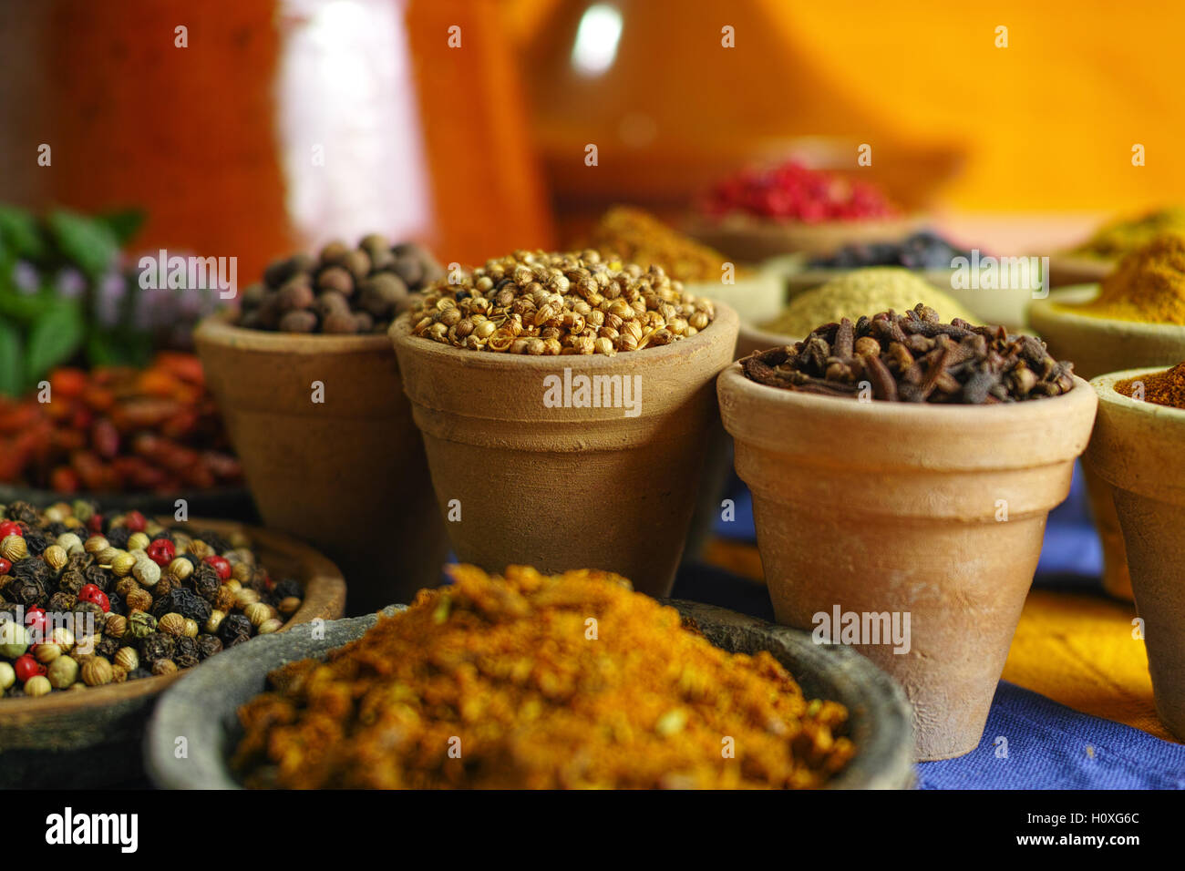 Collection of different spices in old clay bowls in colorful oriental ...