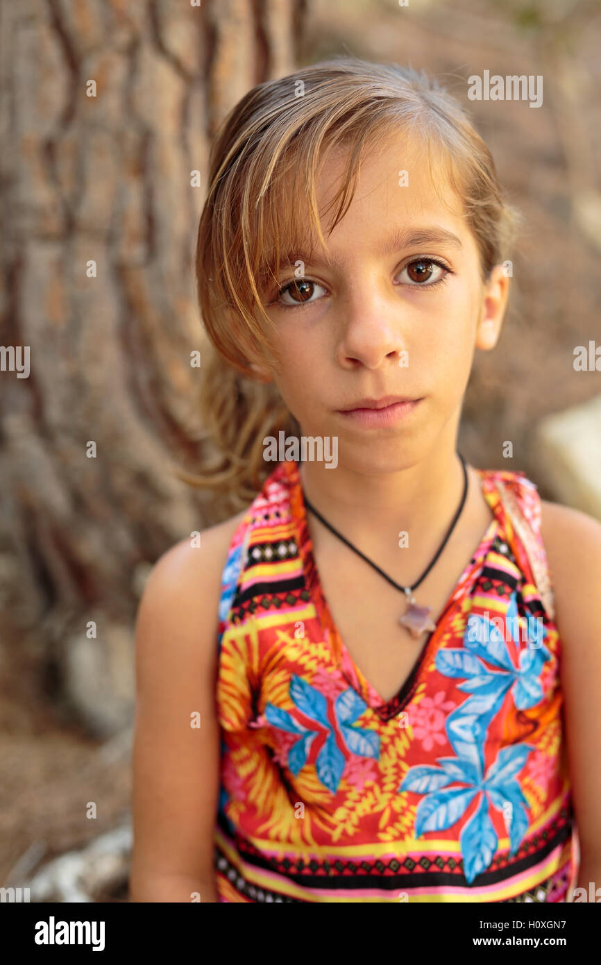 Portrait of girl next to a tree with a very colorful dress Stock Photo ...