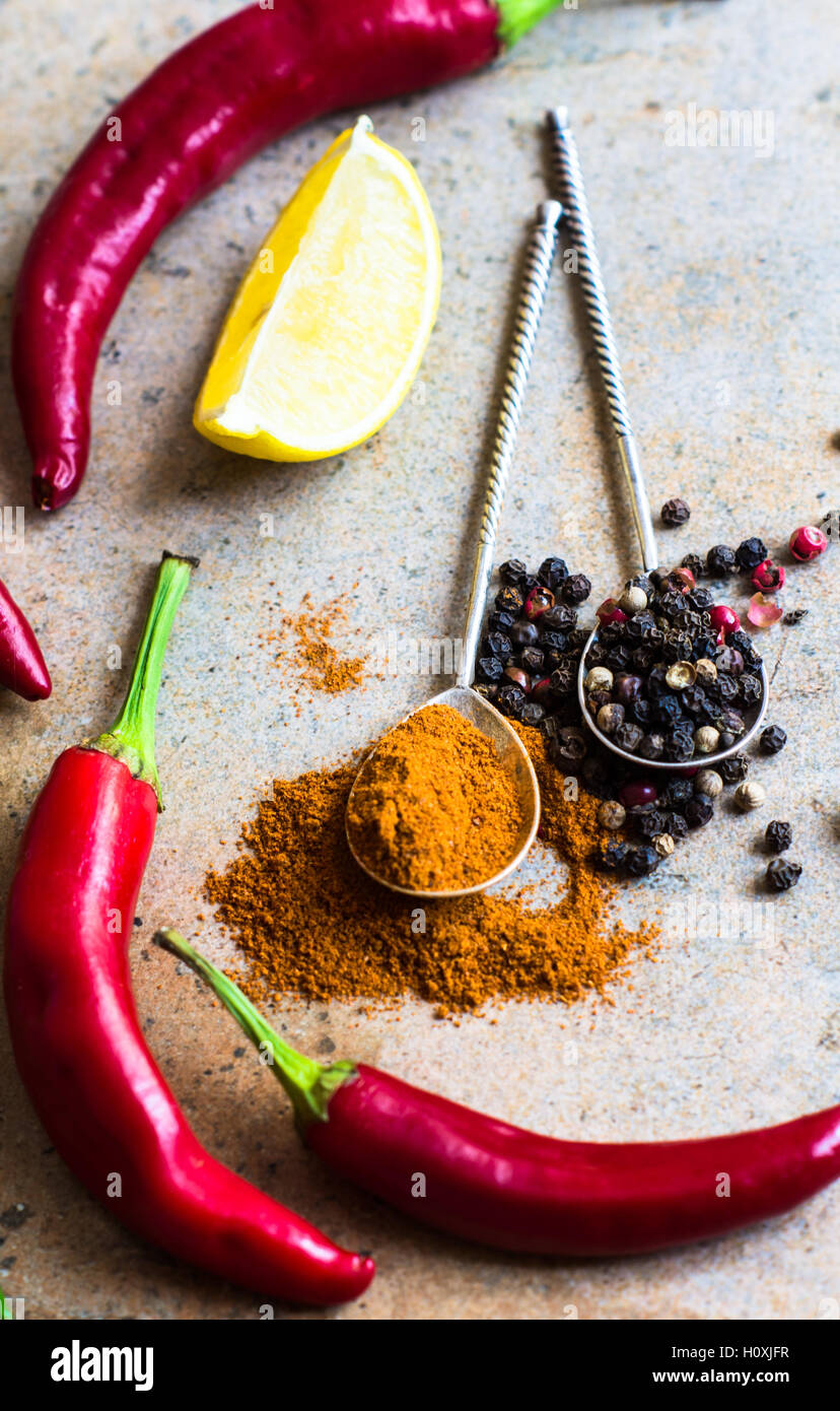 Different types of pepper spice on stone table Stock Photo - Alamy
