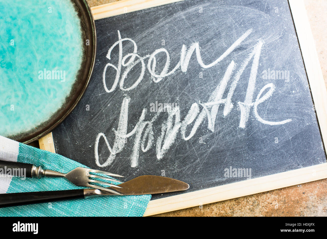 Bon appetite on a chalkboard with rustic silverware and napkin Stock ...