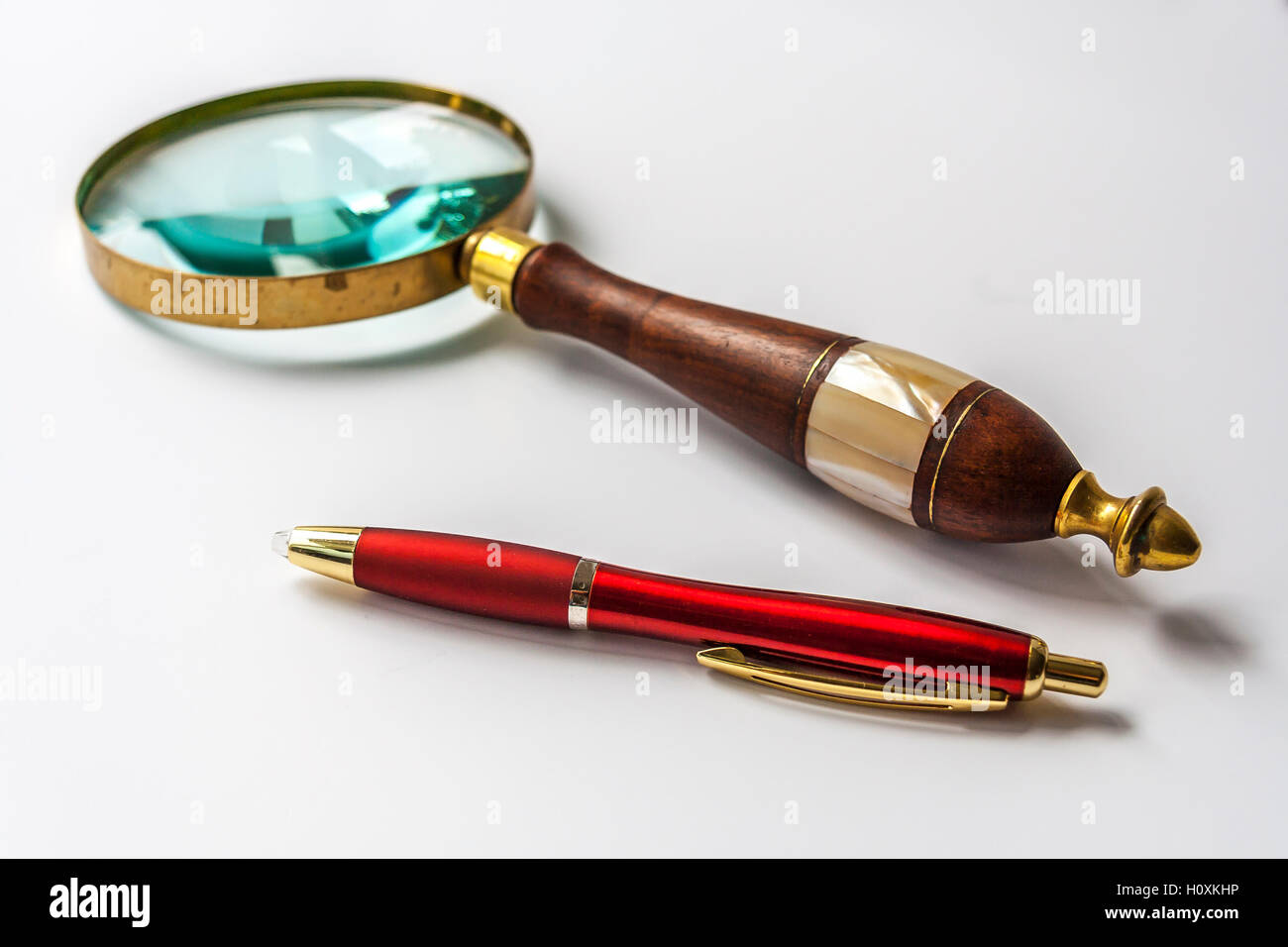 Magnifying Glass And Ballpoint Pen Stock Photo - Alamy