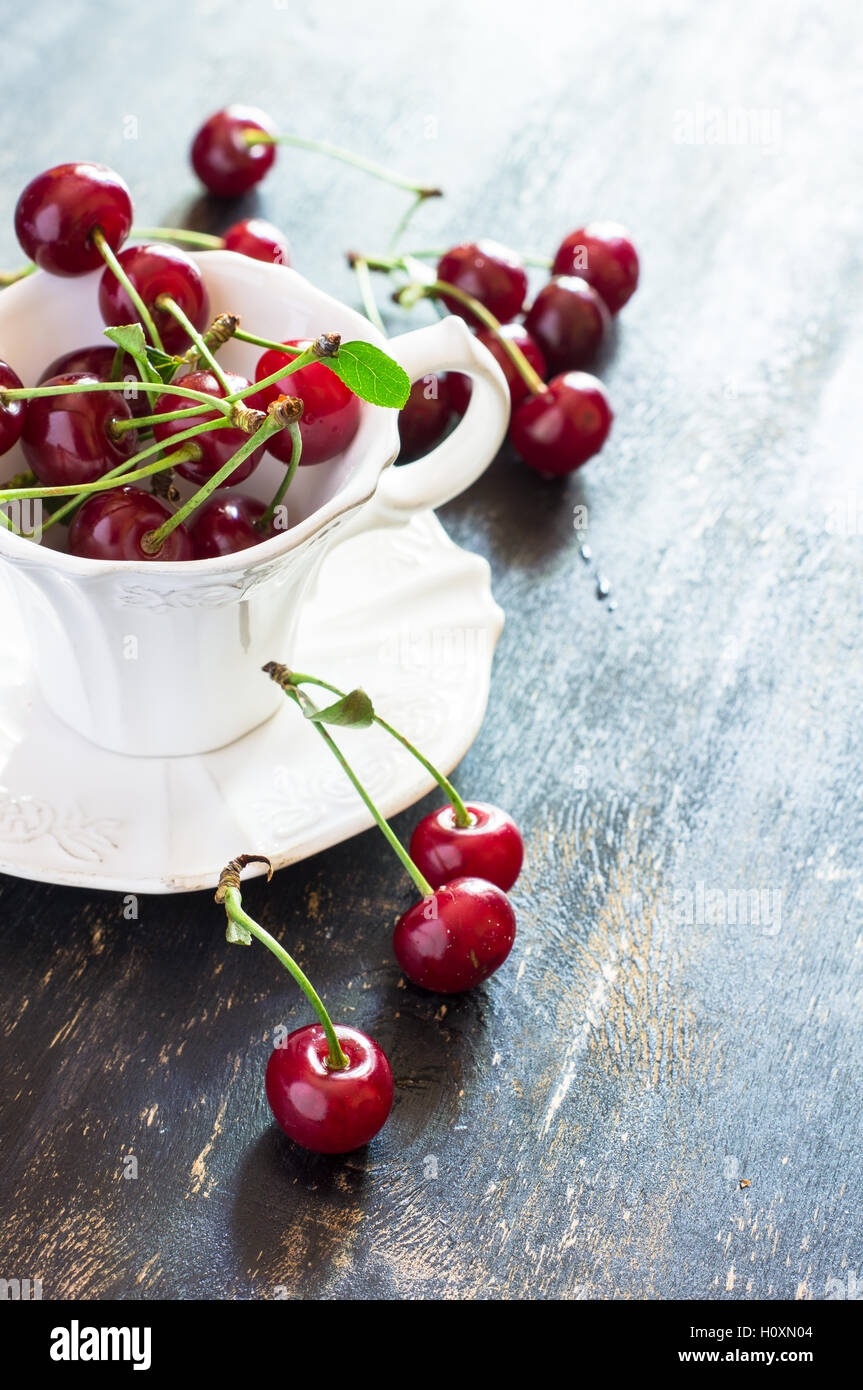 Fresh cherry berries on rustic wooden table and vintage background ...