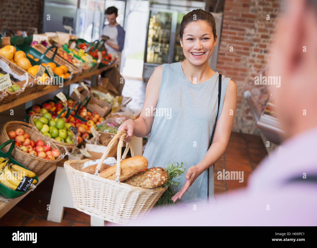 woman basket smiling grocery store worker Stock Photo - Alamy