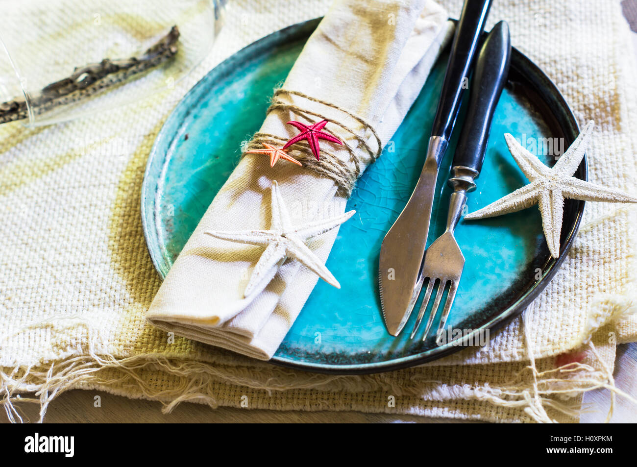 Marine table setting with sea stars and vintage tableware on rustic ...