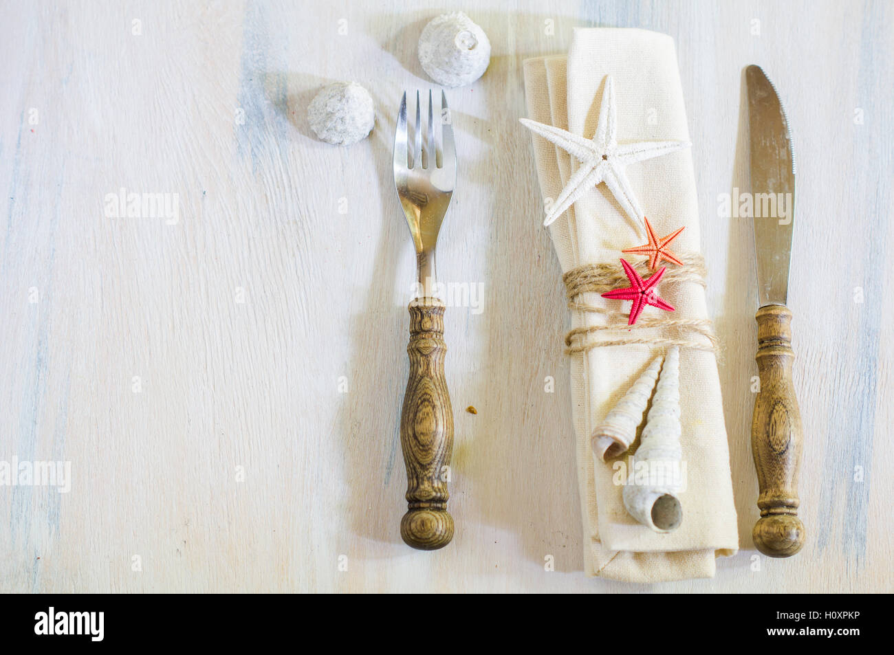 Marine table setting with sea stars and vintage tableware on rustic ...
