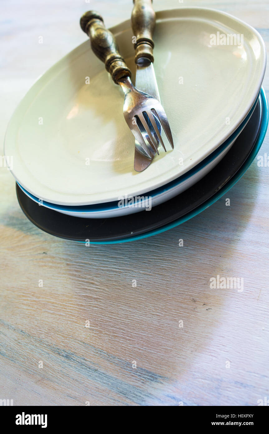 Table setting with vintage porcelain plates and silverware on rustic ...